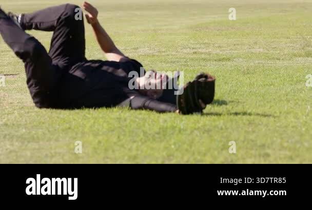 Teammate tossing baseball mid adult man spotting ball, diving with ...