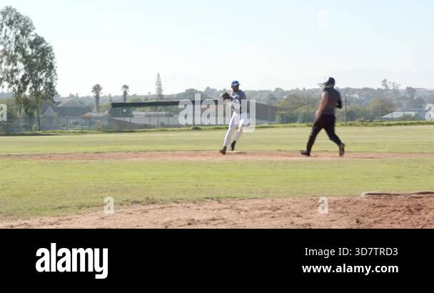 Male baseball team celebrating on mound after incoming throw, infielder ...