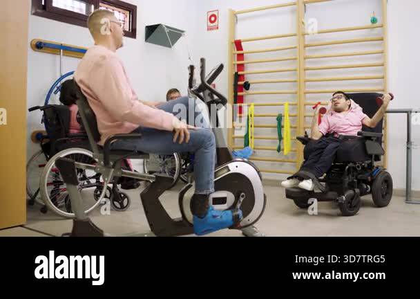 People with disabilities doing physiotherapy exercises in a specialized ...