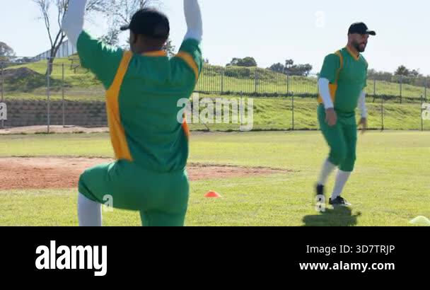 Striding around cone on field coach guiding male players lunging for ...