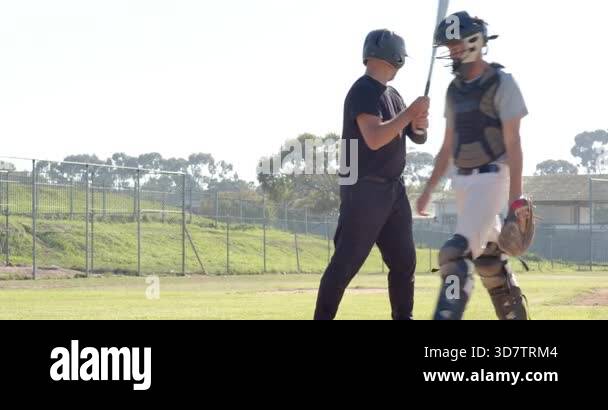 On pitch male batter at home plate tapping bat, swinging as dropped ...