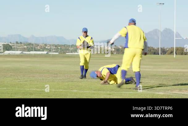 Baseball teammates diving and celebrating catch after batter hitting ...