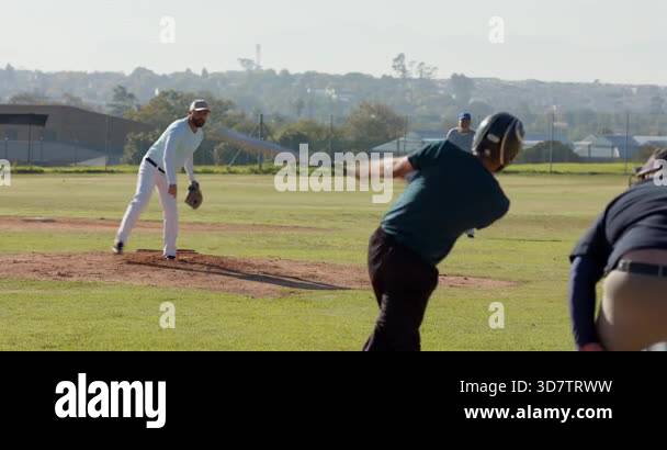 Pitcher delivering pitch to plate on baseball field umpire walking to ...