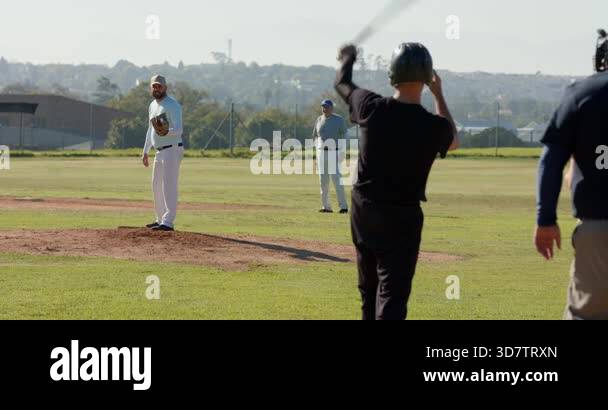 Pitcher glancing at first baseman on mound winding up and releasing ...