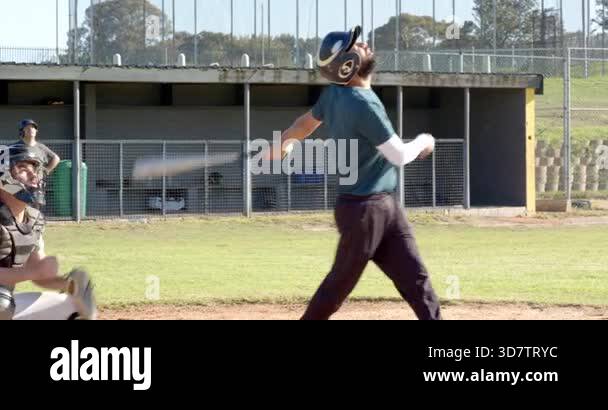 Catcher signaling pitch at home plate male batter swinging bat missing ...