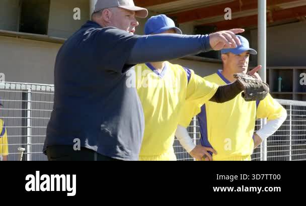 Turning right, male coach and players outlining field positions at ...