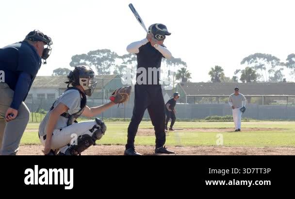Pitcher pitching, batter swinging and missing, catcher chasing ball as ...