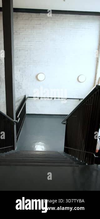 Vertical video: Facing deadline Diverse team entering stairwell ...