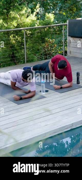 Vertical video: Diverse men performing plank transitioning twisting ...