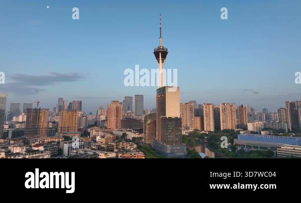 An iconic telecommunications tower dominating a modern city skyline at ...