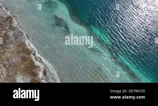 Aerial close-up view of the meeting point between shallow, sandy ...
