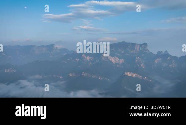 High-angle panoramic view of vast, layered mountains under a clear blue ...
