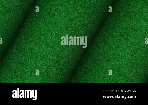 Emerald green rolls turn in steady motion displaying dense felt texture ...