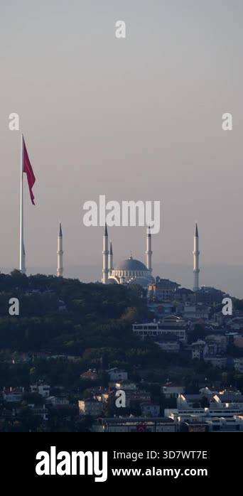 Stunning sunset view of a mosque and Turkish flag over the city skyline ...