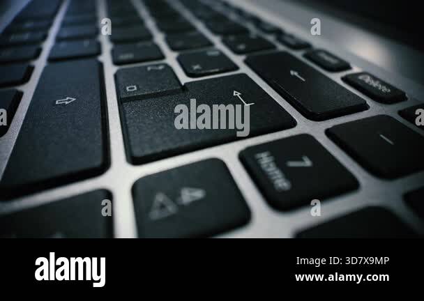 Macro closeup of pressing the enter key on a laptop keyboard, showing ...