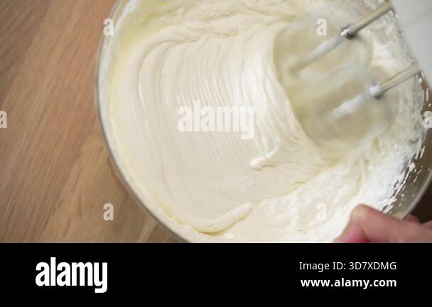 Whipping a Cream and the ingredients for baking with a mixer. Whipped ...