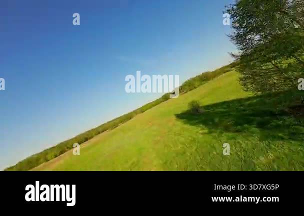 A low and fast drone flight over a river and meadow Stock Video Footage ...