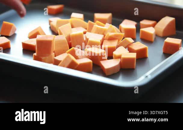 fresh cut squash cubes arranged in baking tray Stock Video Footage - Alamy