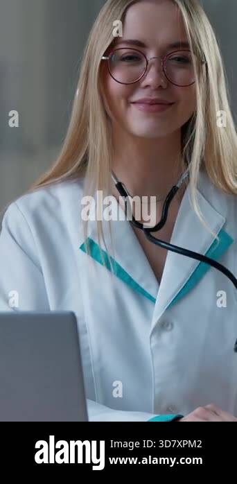Caucasian woman female doctor posing in clinic showing stethoscope ...