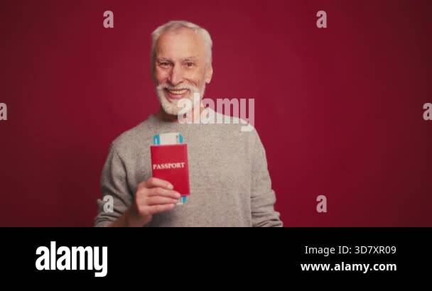 Smiling, happy senior gray haired man holding passport and boarding ...
