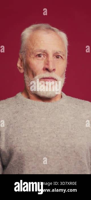 Portrait of tired, sad senior man wiping forehead with his hand looking ...