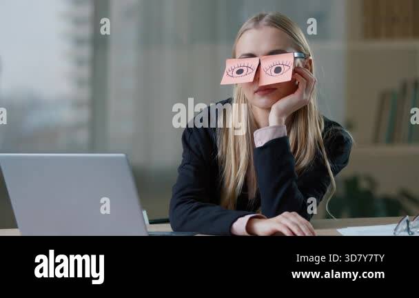 Humorous Caucasian business woman with sticky notes on eyes glasses at ...