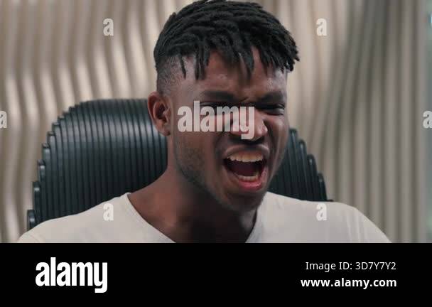 Headshot aggressive African American man yelling shouting furious in ...