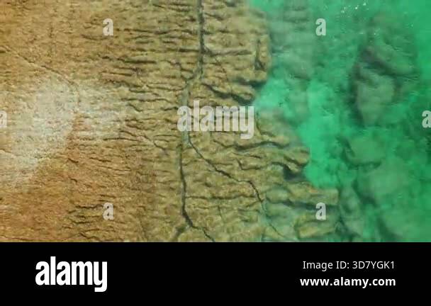 Top view of underwater rock formations in shallow emerald green coastal ...