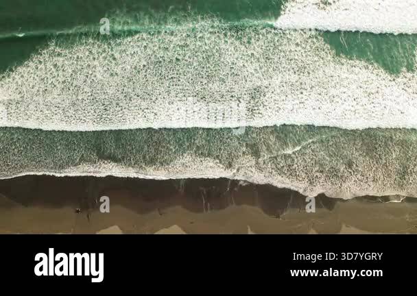 Tropical sandy beach with long ocean waves in slow motion, aerial top ...