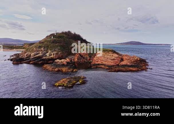 The drone captures a stunning aerial view of a secluded island in ...