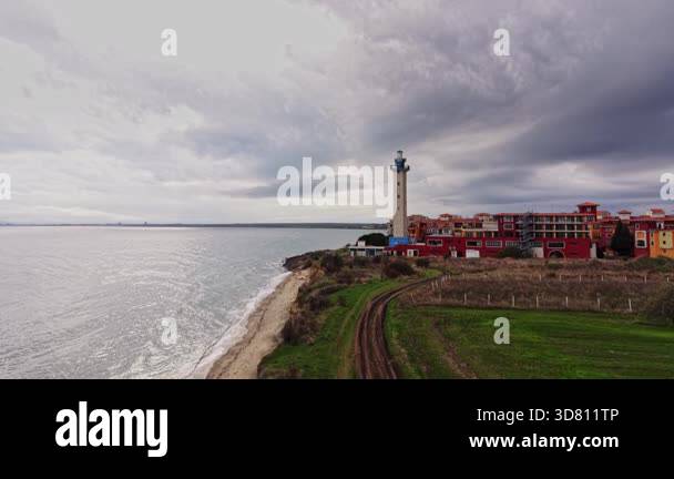 This stunning aerial shot showcases a lighthouse standing tall by the ...