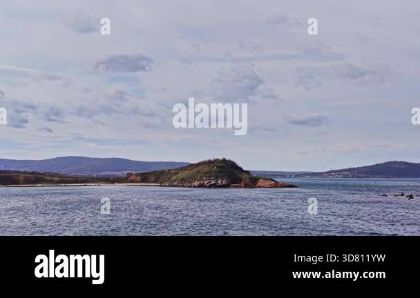 Aerial view showcases a small, green island surrounded by calm waters ...
