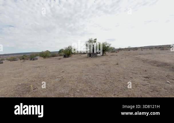 Drone flying towards abandoned stone ruins in a desolate landscape ...