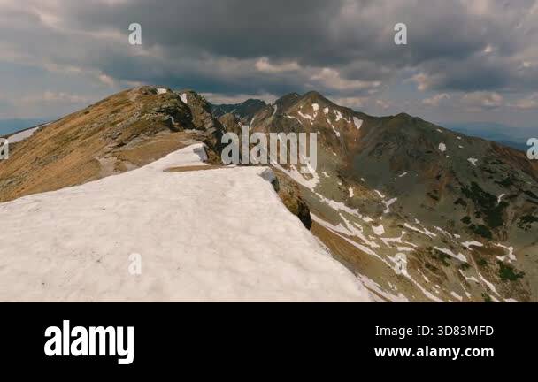 Peaceful footage of walking on a melting snow drift along a spring ...