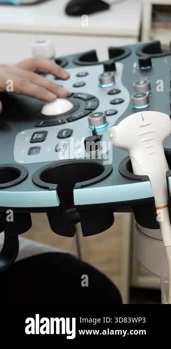 Close up of an ultrasound control panel with operators hand adjusting ...