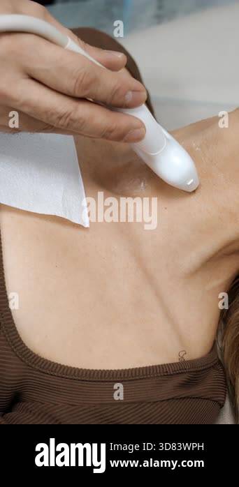 Close up of a neck ultrasound procedure using a handheld probe on a ...