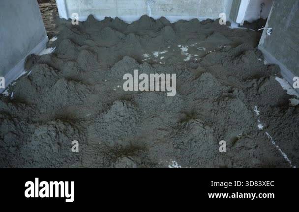 Wet screed mounds on subfloor during interior renovation work ...