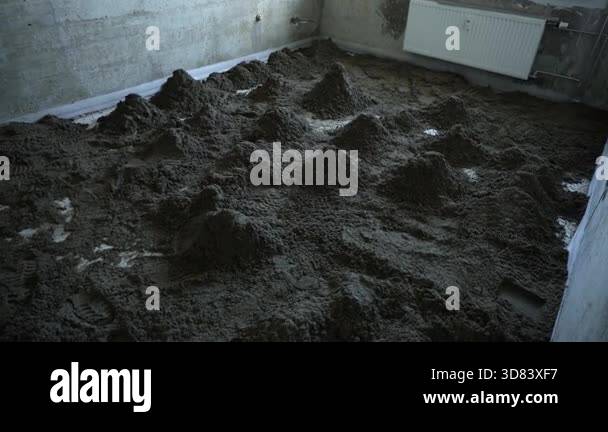 Conical sand mounds cover the floor as workers leave boot prints and ...