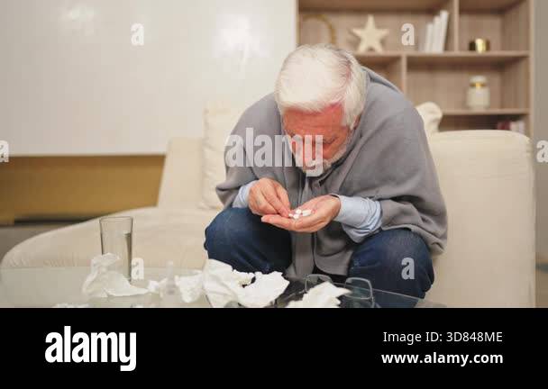 Healthcare medicine. Senior man with high fever symptoms illness cold ...