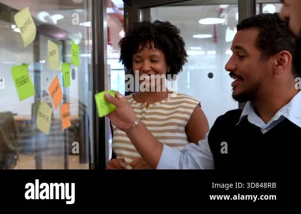 Young creative team of diverse colleagues brainstorming ideas using ...