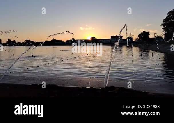 Beautiful sunset water fountain footage with golden light, gentle water ...