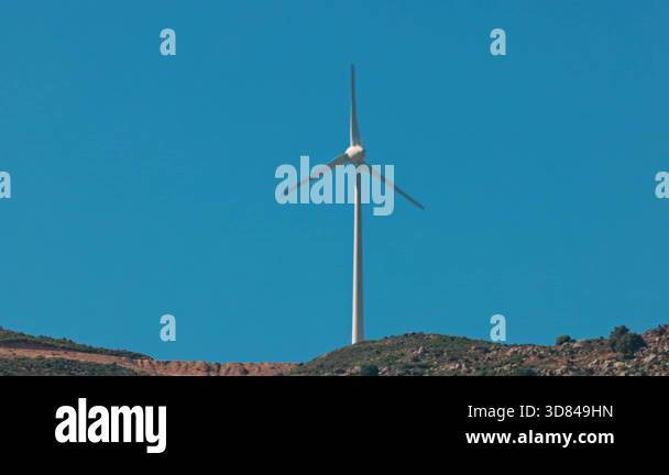 Close up view of rotating wind turbine blades in mountains against ...