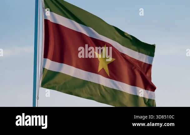 Suriname, Paramaribo: Cinematic Waving National Flag Against Blue Sky ...