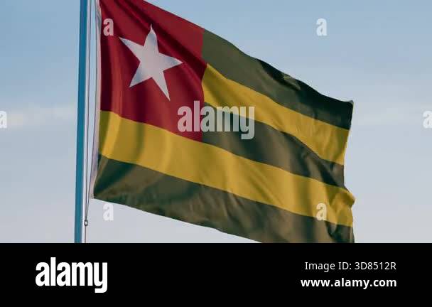 Togo, Lome: Cinematic Waving National Flag Against Blue Sky Stock Video ...