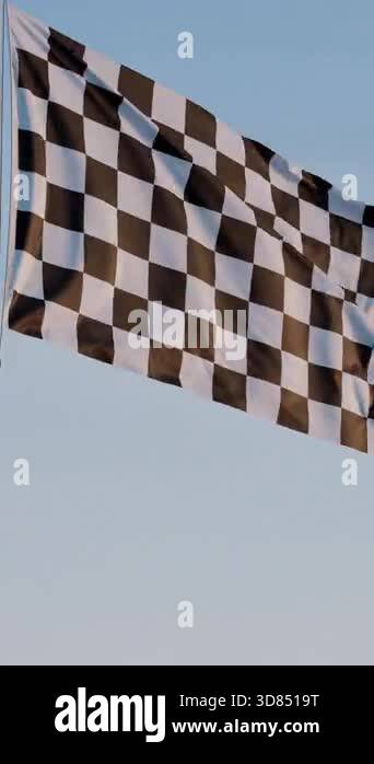 Checkered Flag: Cinematic Vertical Waving Racing Flag Against Blue Sky ...