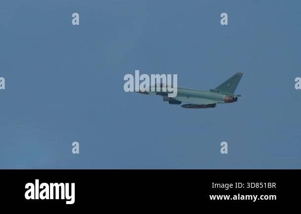 Side view of a German military fighter jet in flight under a clear sky ...