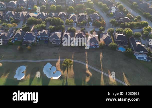 Rows of large mansion homes with pools and trampolines back onto a ...