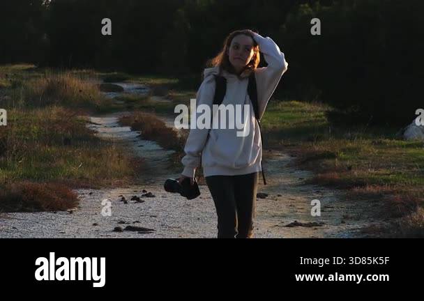 A woman walking slowly with camera at Gediz Delta in Sasal Bird ...