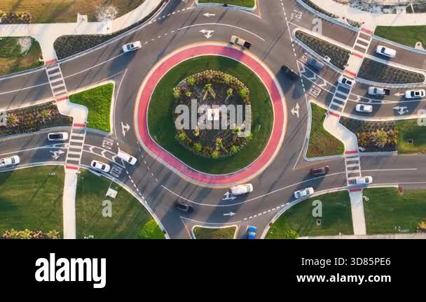 Aerial view of roundabout intersection on American road with moving ...