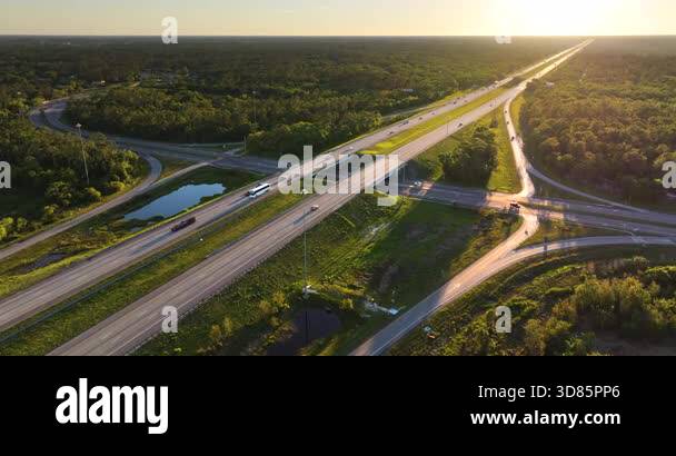 Wide multilane expressway crossroad with overpass ramps and flowing ...